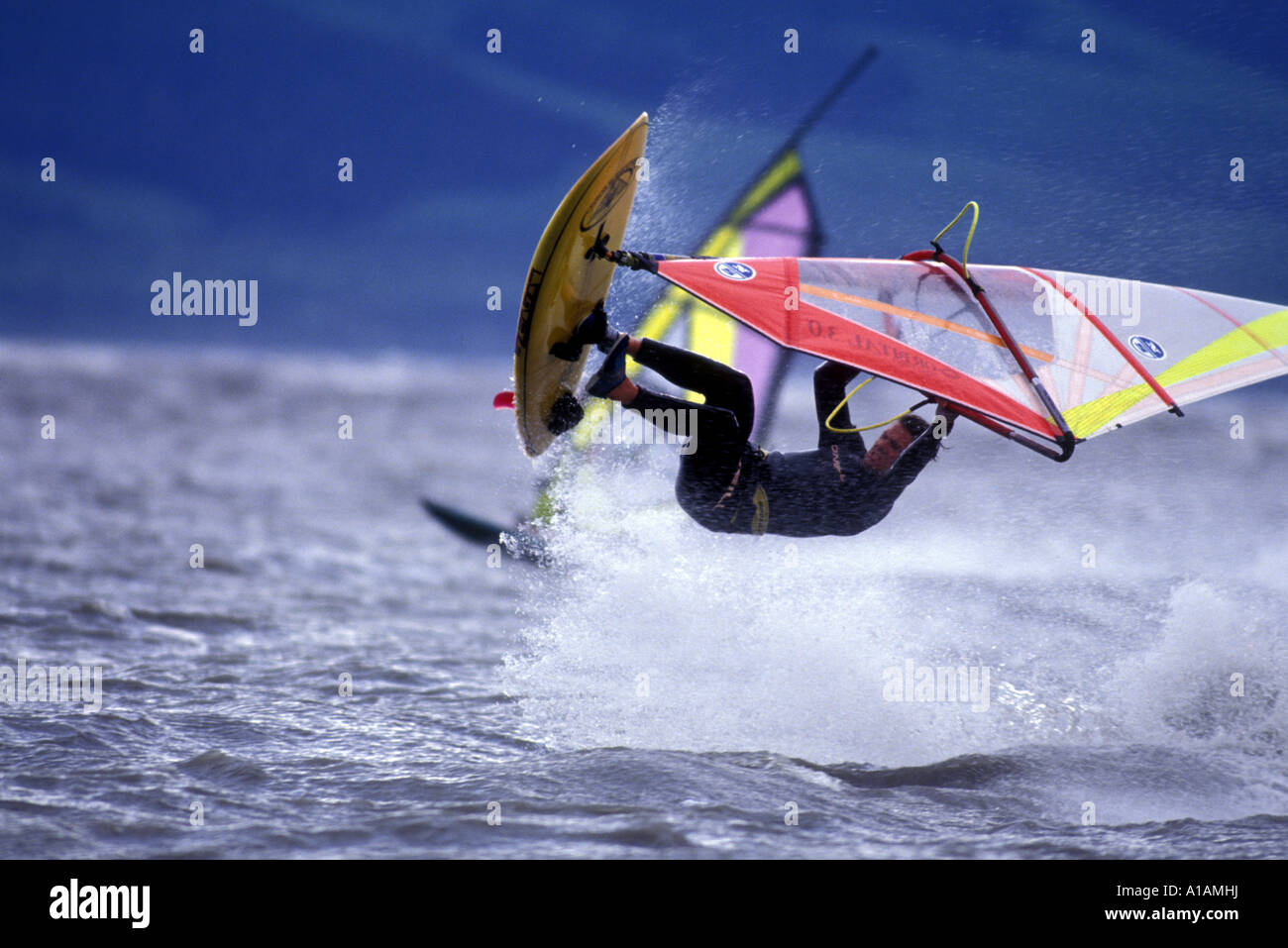 USA Alaska Chugach State Park Windsurfer catches air along cold and ...
