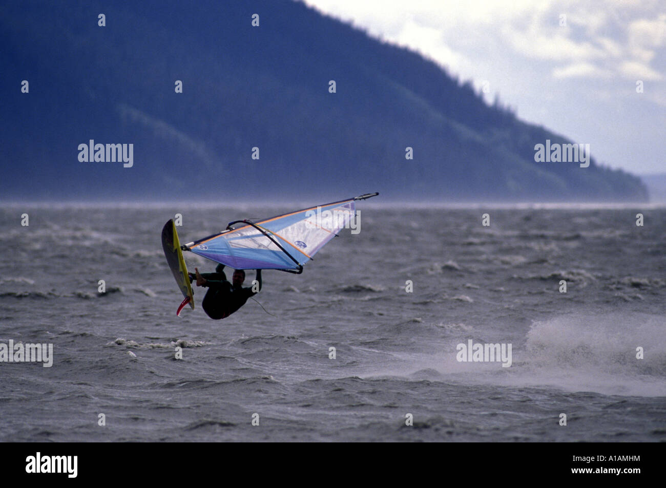 USA Alaska Chugach State Park Windsurfer catches air along cold and ...