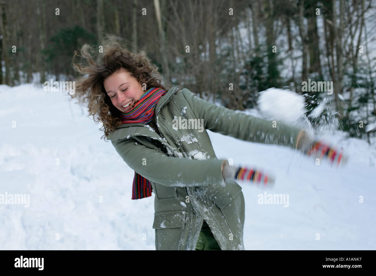Woman in snowball fight Stock Photo - Alamy