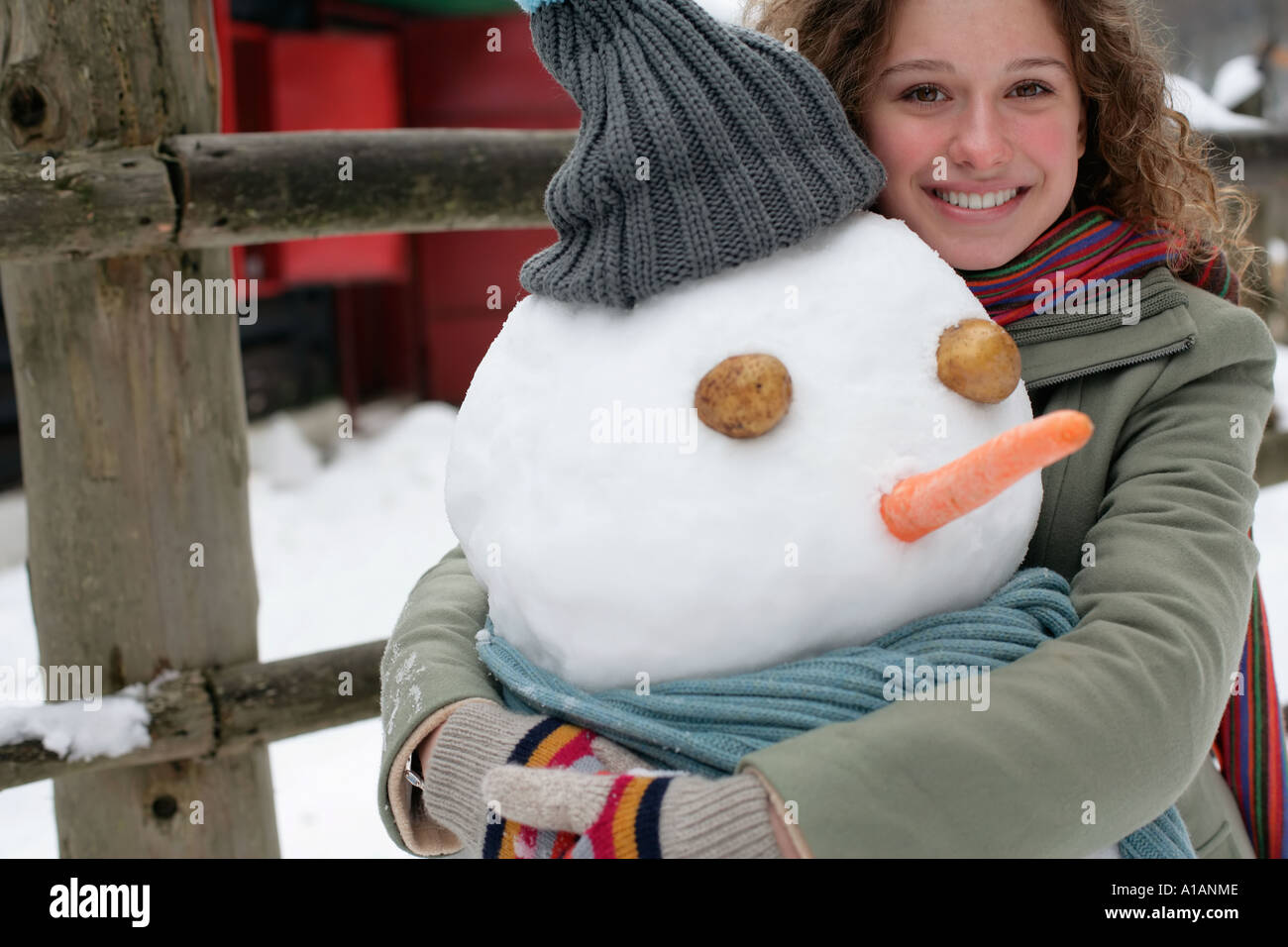 Woman hugging a snowman Stock Photo - Alamy