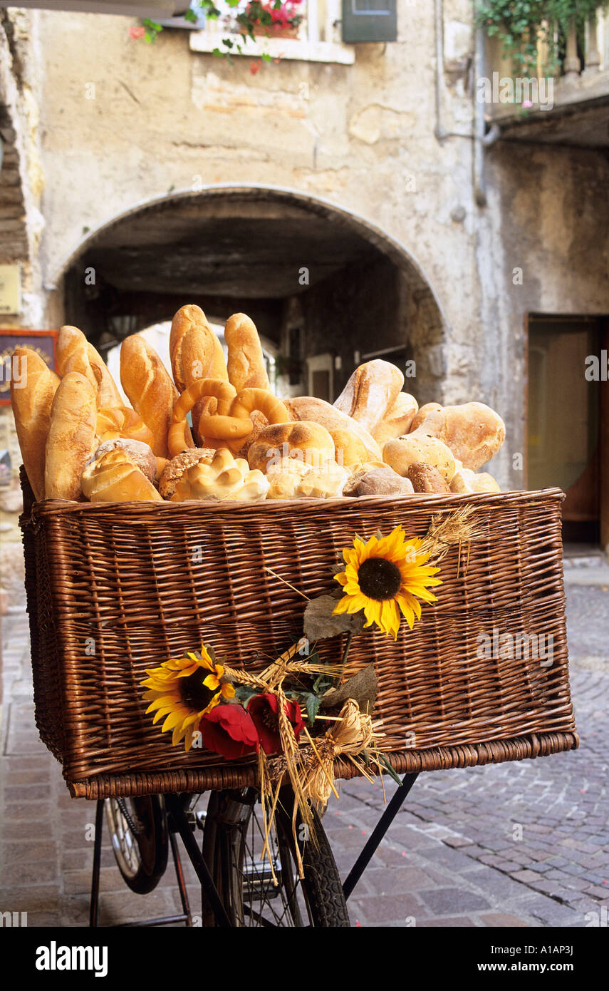 Bakers bicycle with different types of bread and a sunflower on the ...