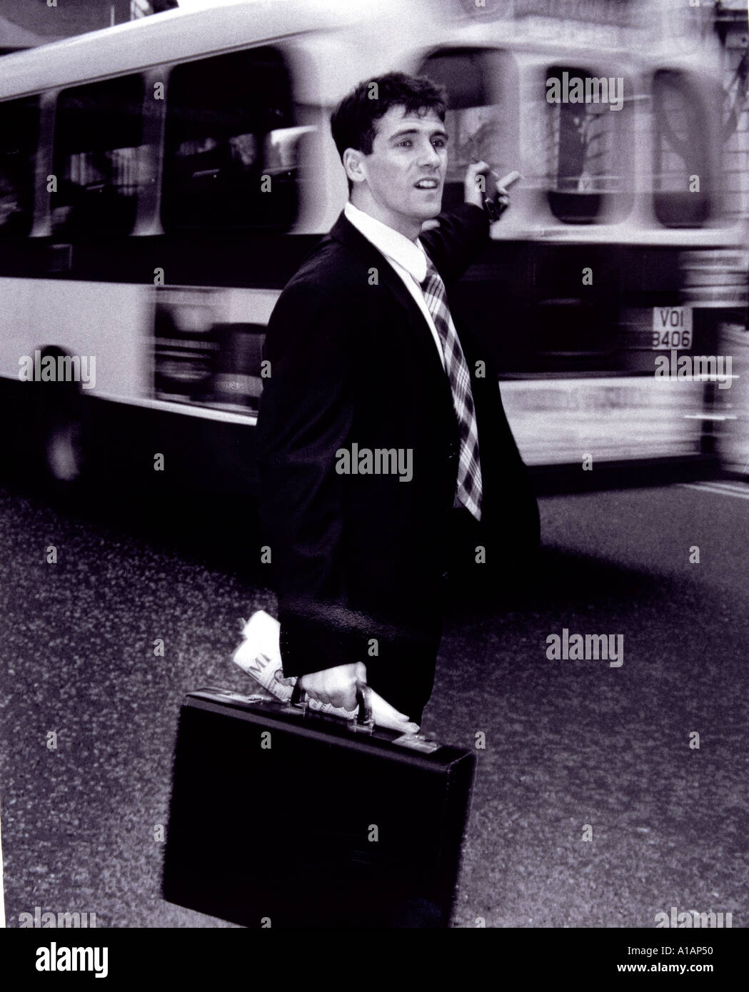White collar worker hailing a Taxi Stock Photo - Alamy