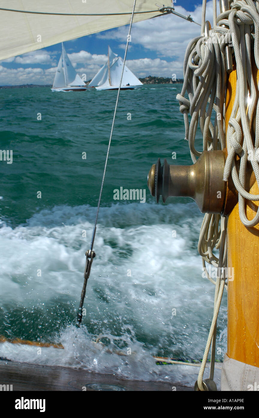 A brass winch and cleated off lines on the mast of a classic sailing ...