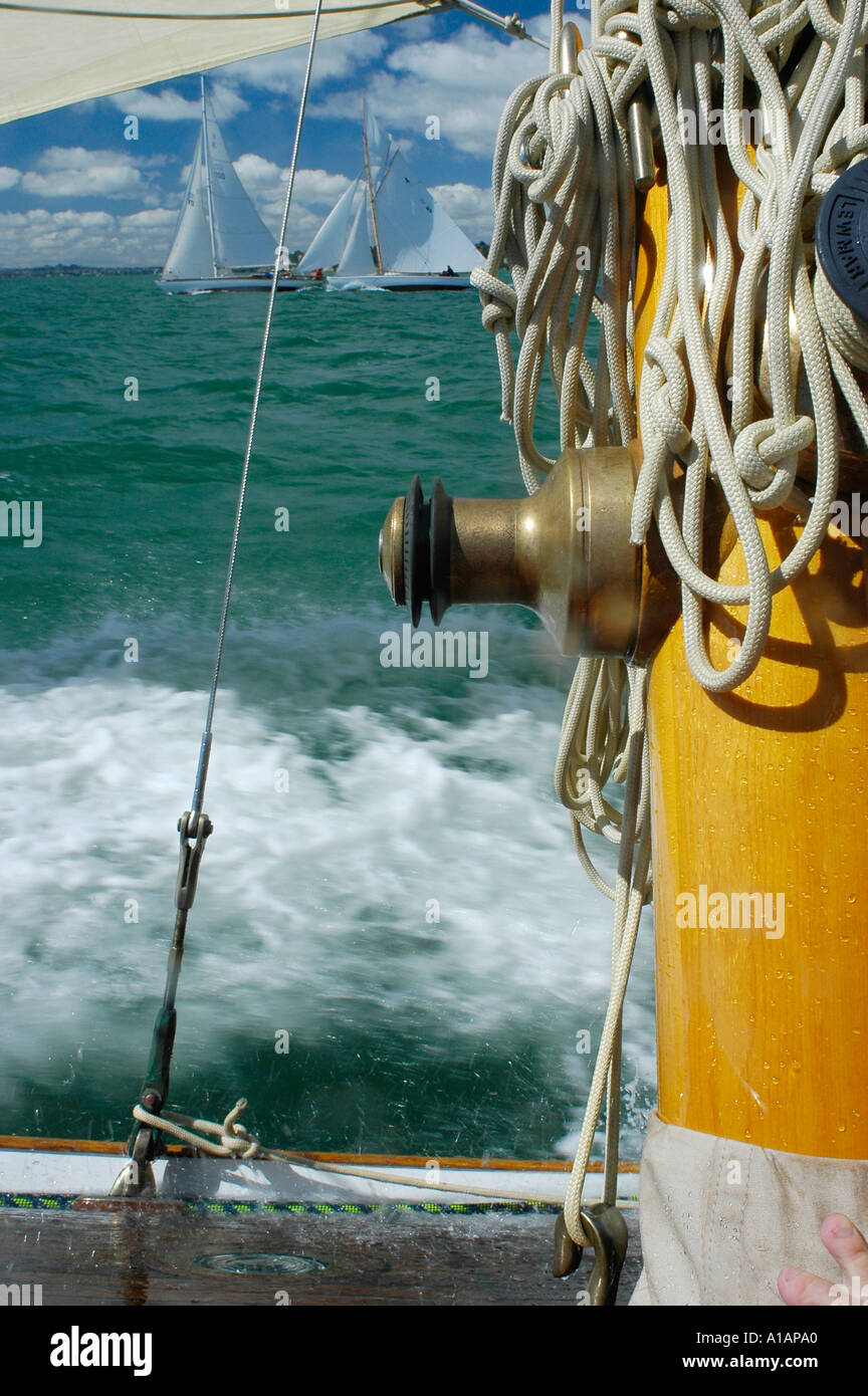 A brass winch and cleated off lines on the mast of a classic sailing ...