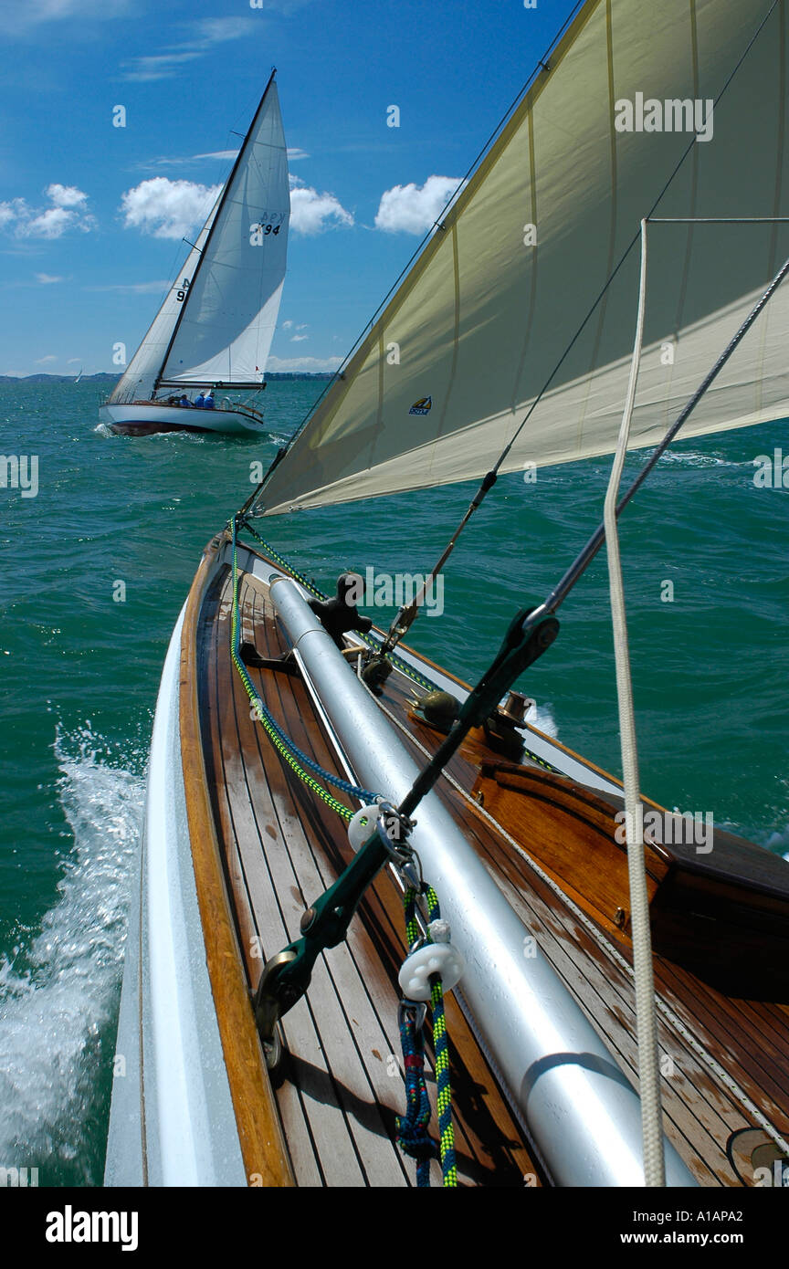 Bow of a classic racing yacht powering through a calm sea in pursuit of ...