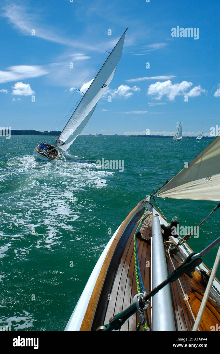 Bow of a classic racing yacht powering through a calm sea in pursuit of ...