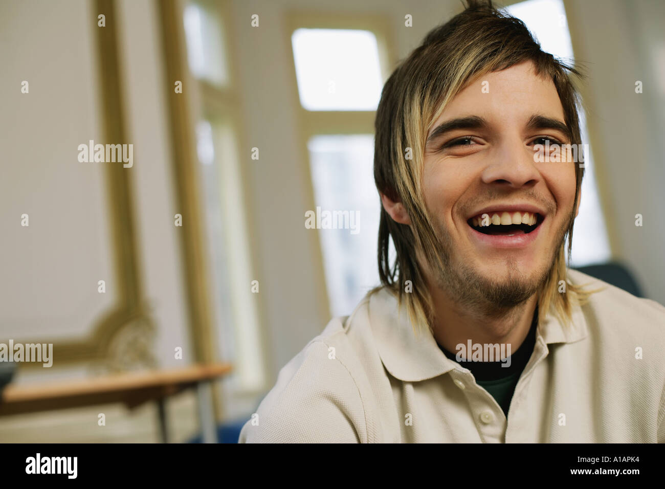 Young man laughing Stock Photo - Alamy