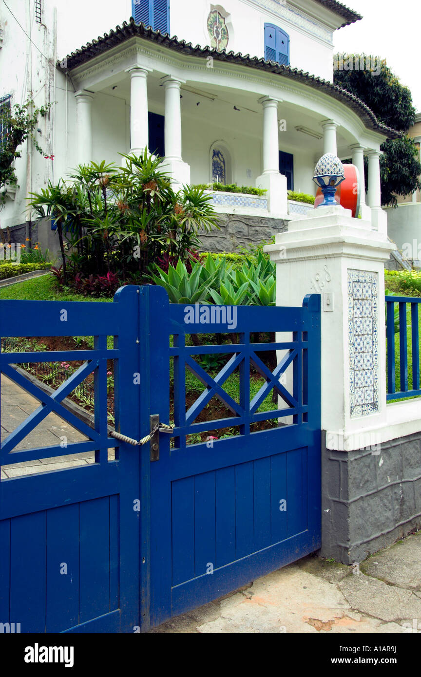 A colorful gate and veranda with a building of colonial architecture in ...