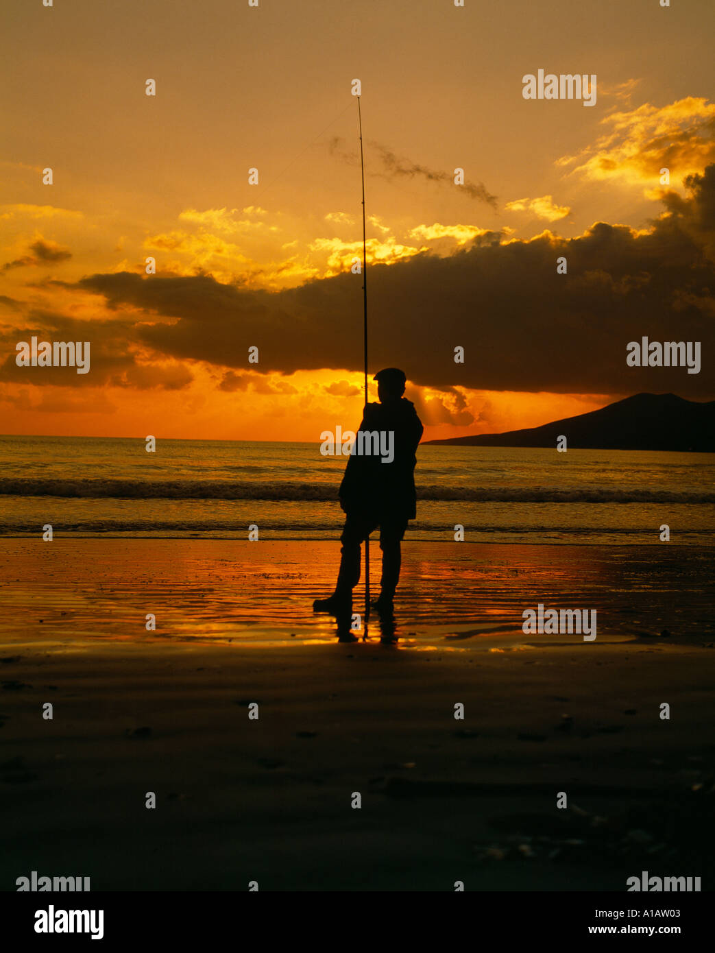 sea angler standing on a beach on irelands atlantic west coast at ...