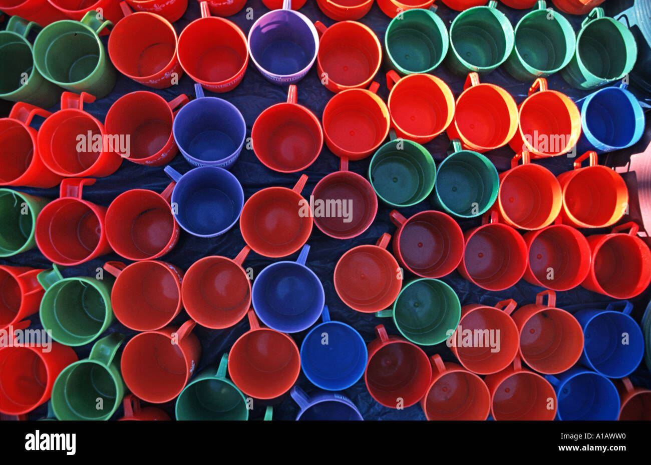 A display of colourful plastic cups carefully organised on a market ...