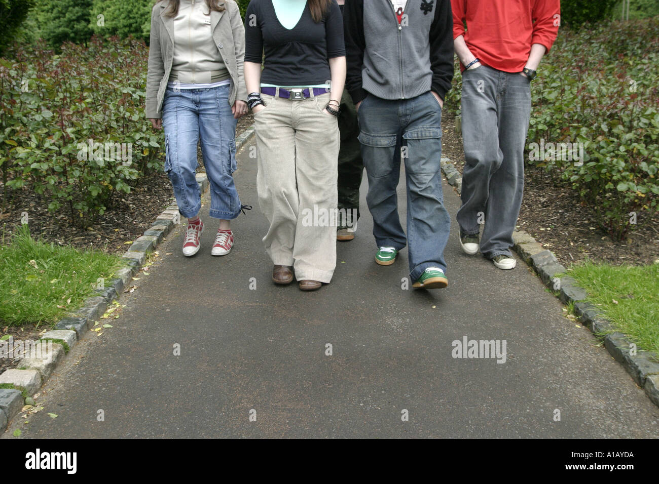 feet and waist shot of young people walking towards the camera on a ...