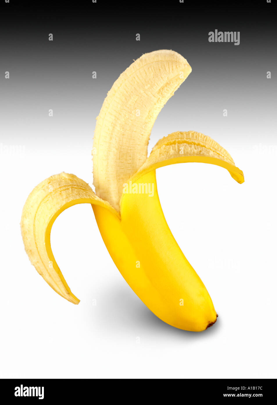 single peeled banana on grad Stock Photo - Alamy