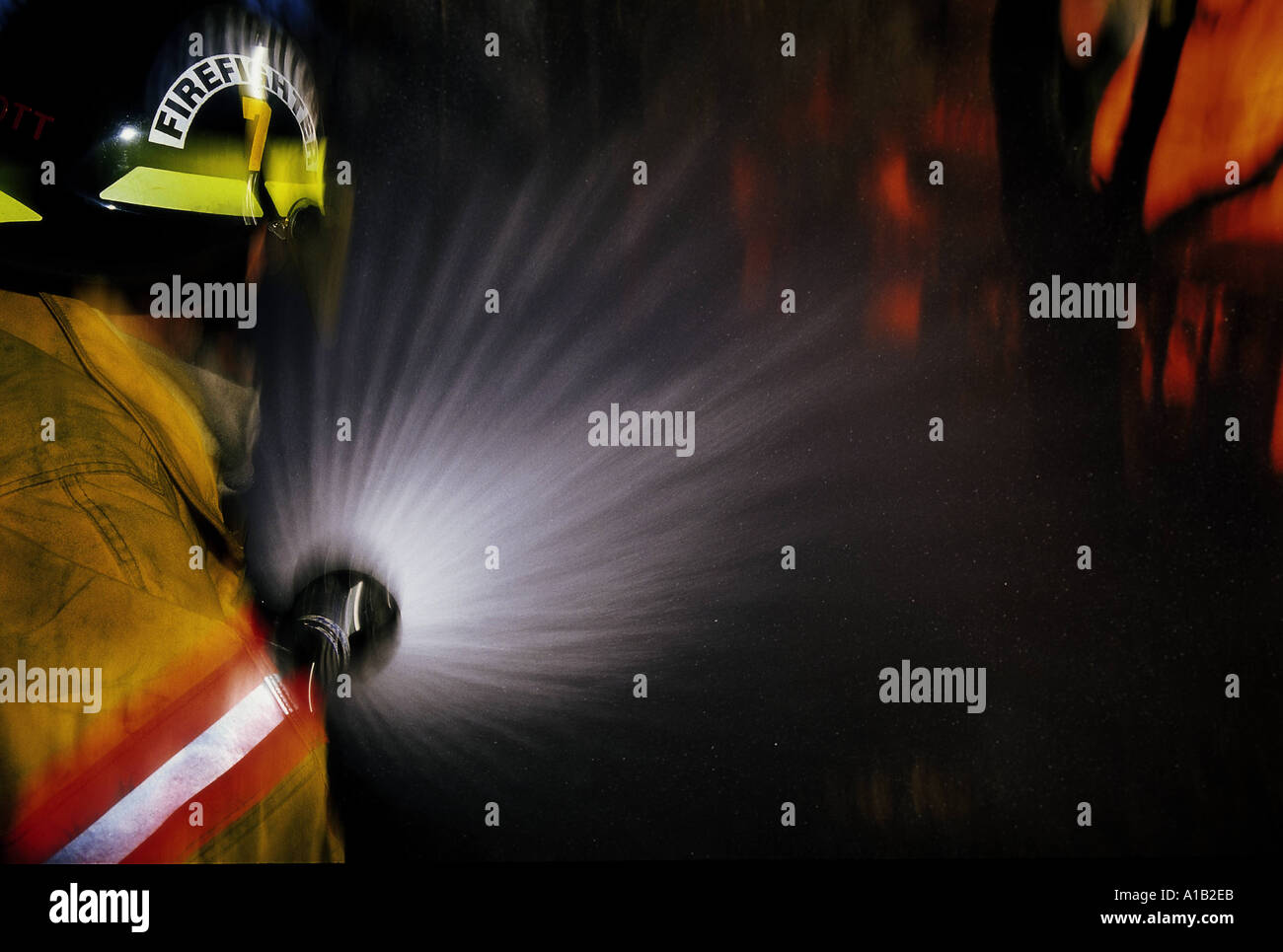 FIRE FIGHTER SPRAYING WATER ON FIRE INFERNO Stock Photo - Alamy