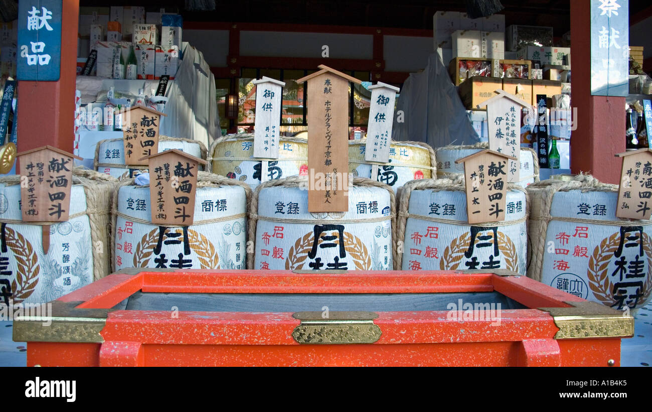 Barrels of sake on display in front of a donation box at the Fushimi ...