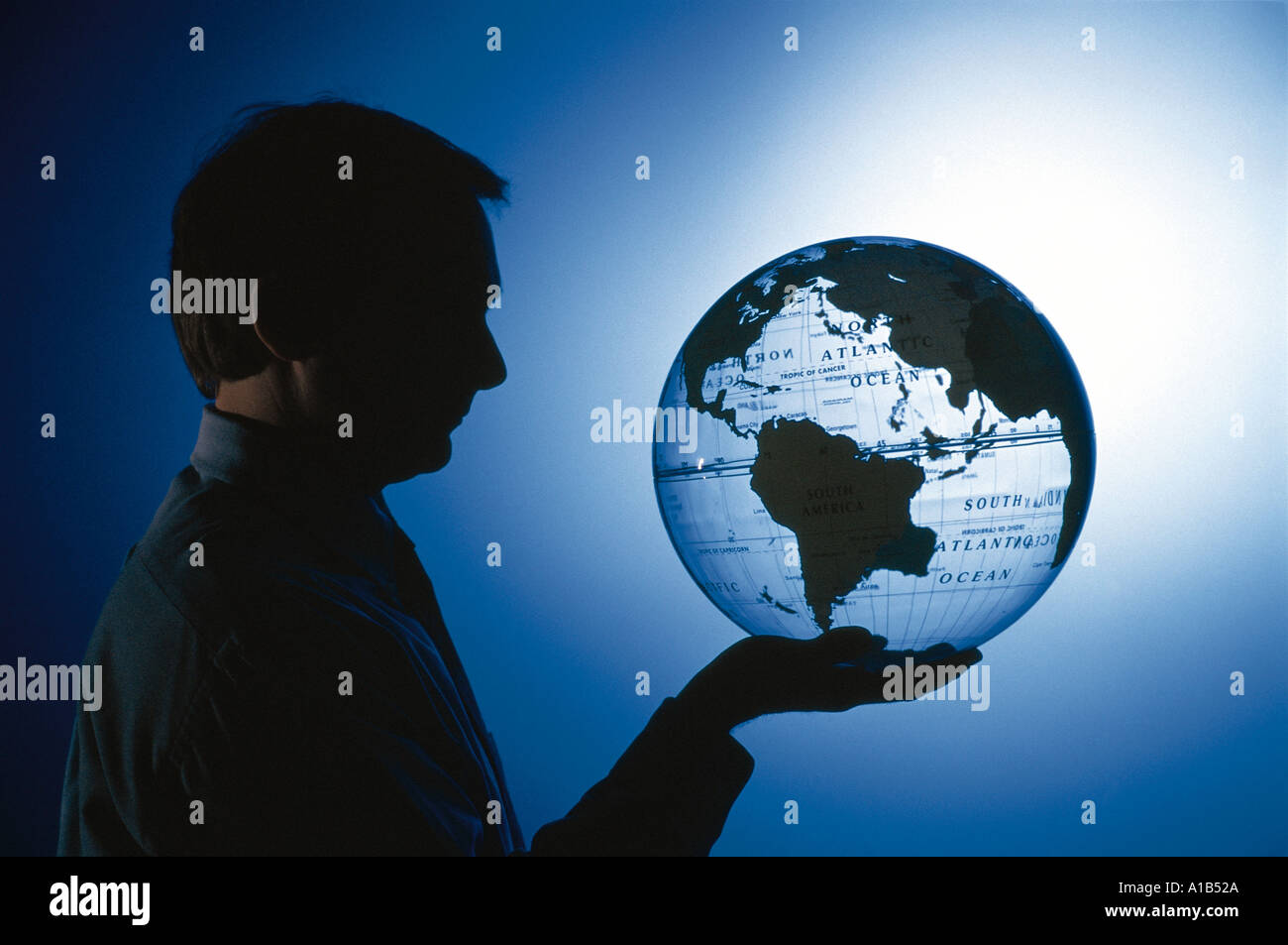 SILHOUETTE OF MAN HOLDING GLOBE Stock Photo - Alamy