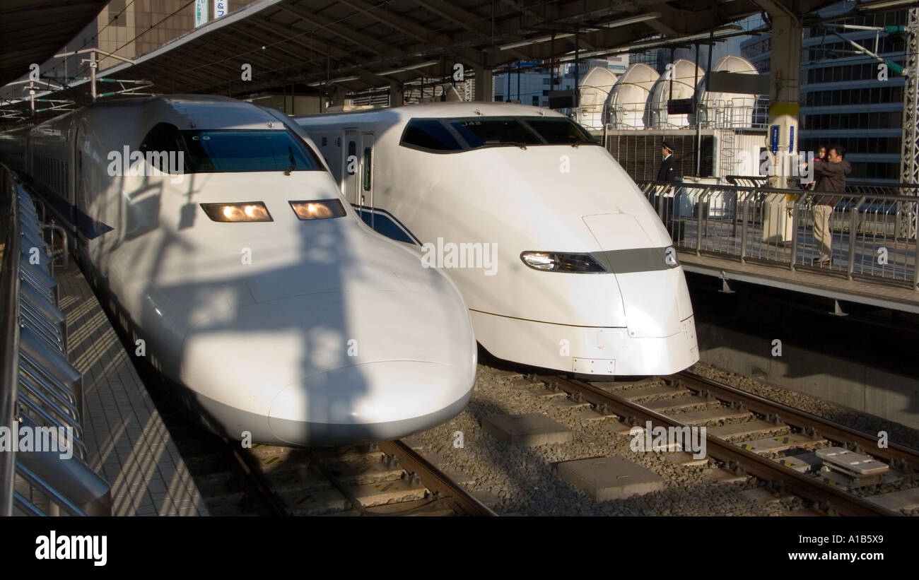 Two Shinkansen trains of different styles side by side at Tokyo Station ...