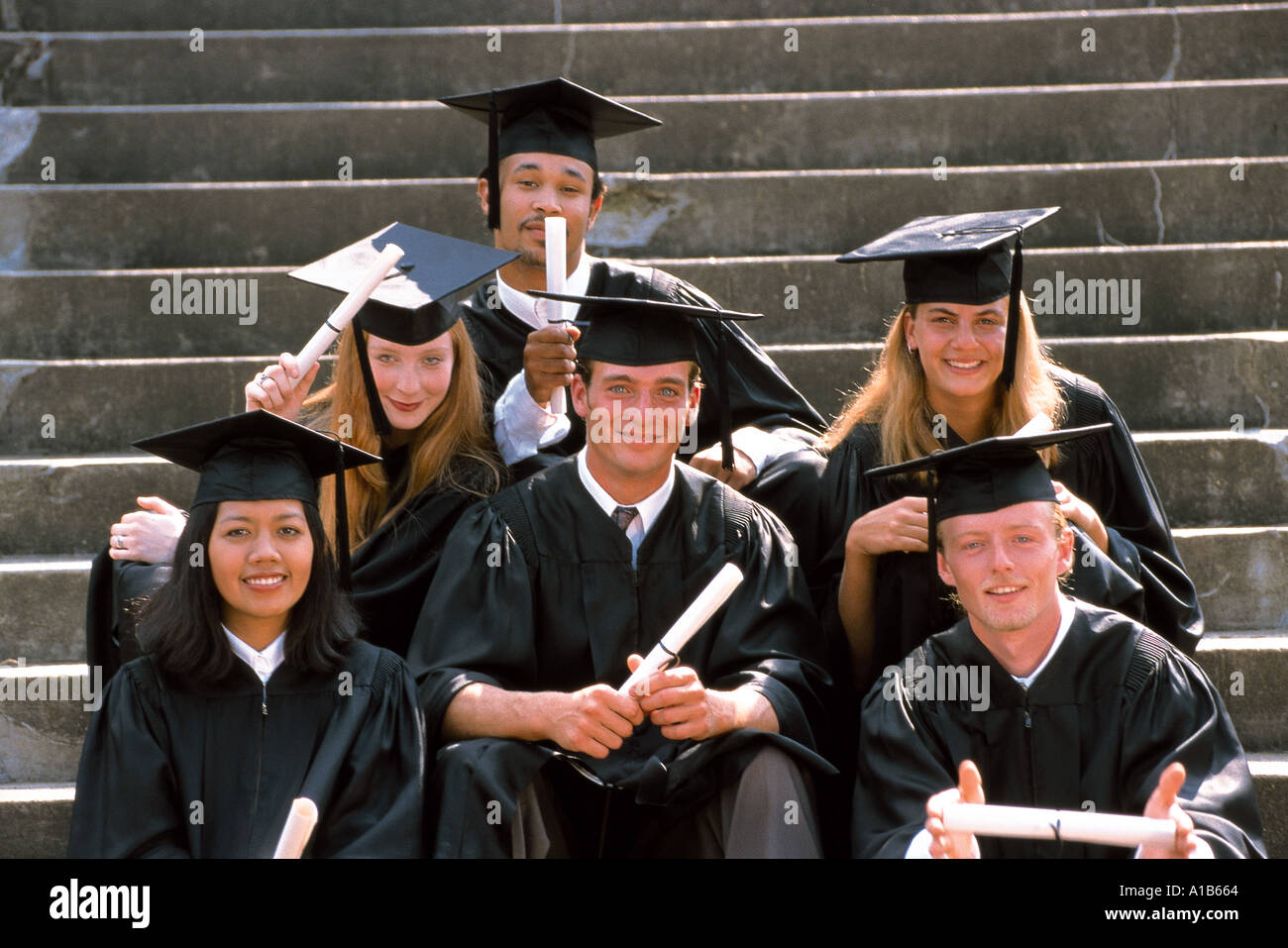 GROUP OF GRADUATES SITTING ON STEPS Stock Photo - Alamy