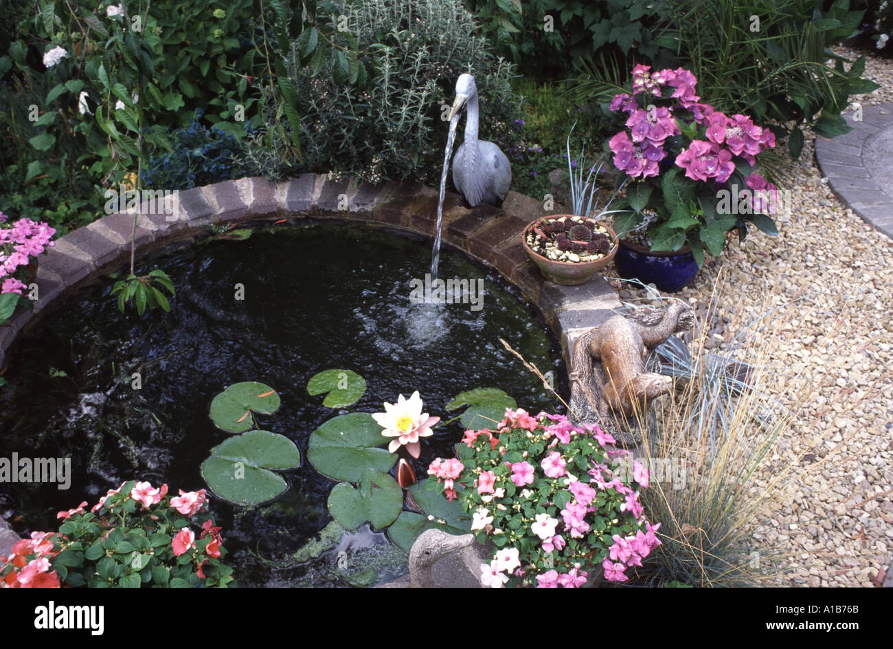 Garden pool with fountain water feature water lily Stock Photo - Alamy