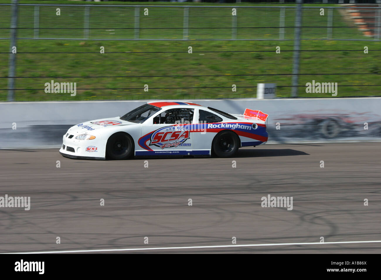 V8 Nascar type stock cars racing on a banked oval circuit Stock Photo ...