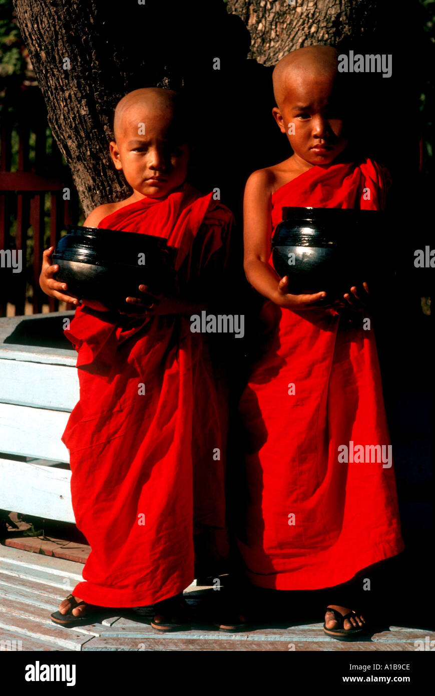 Two child novice monks holding bowls Shwe Nandaw Monastery Mandalay ...