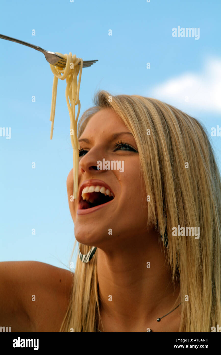 Woman eating spaghetti meal Stock Photo - Alamy