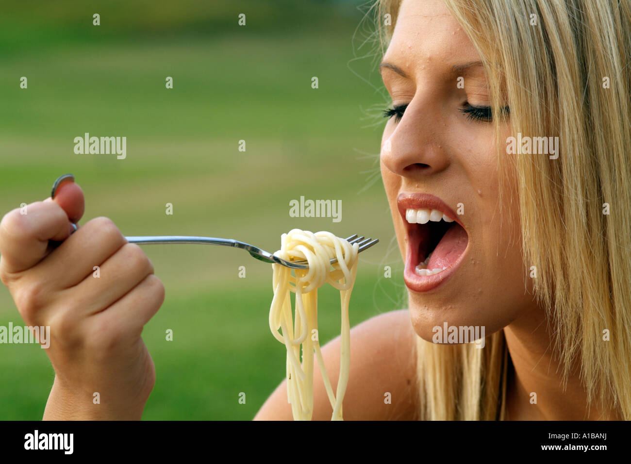 Woman eating spaghetti meal Stock Photo - Alamy