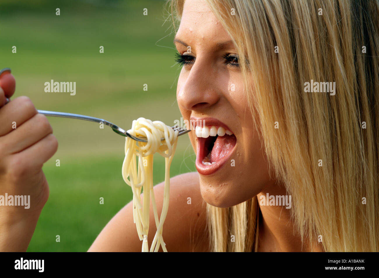 Teenager girl eating spaghetti meal Stock Photo - Alamy