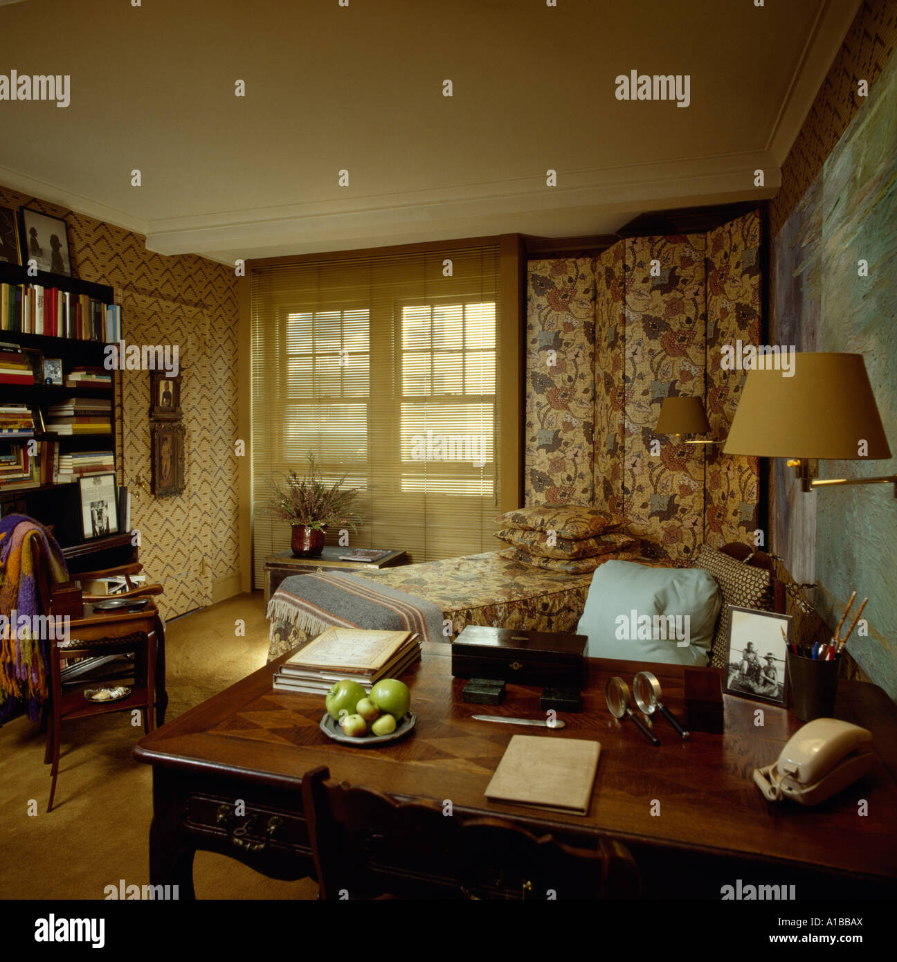 Antique desk in eighties guest room with patterned screen in the corner ...