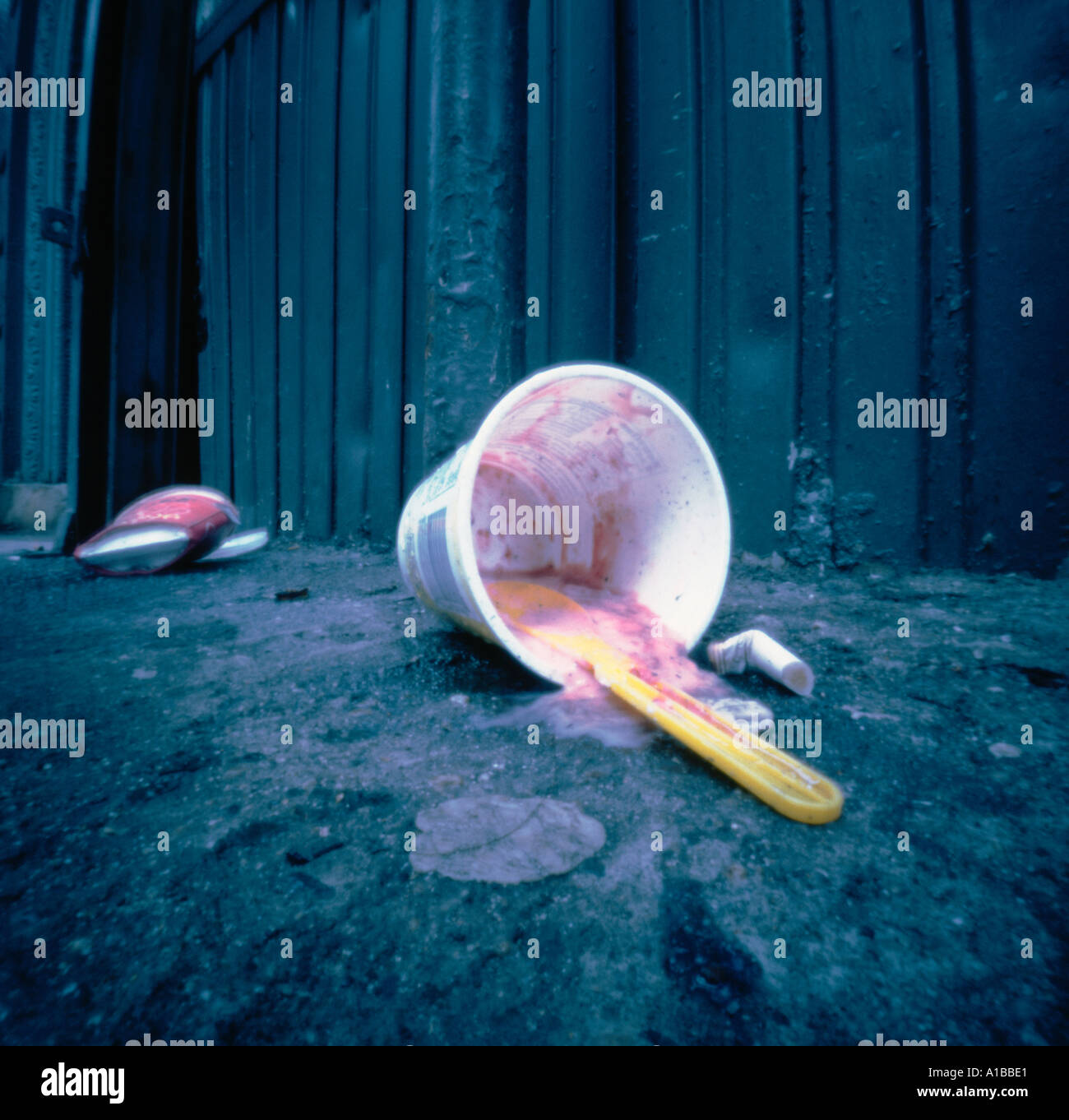 empty yogurt container on the ground Stock Photo - Alamy