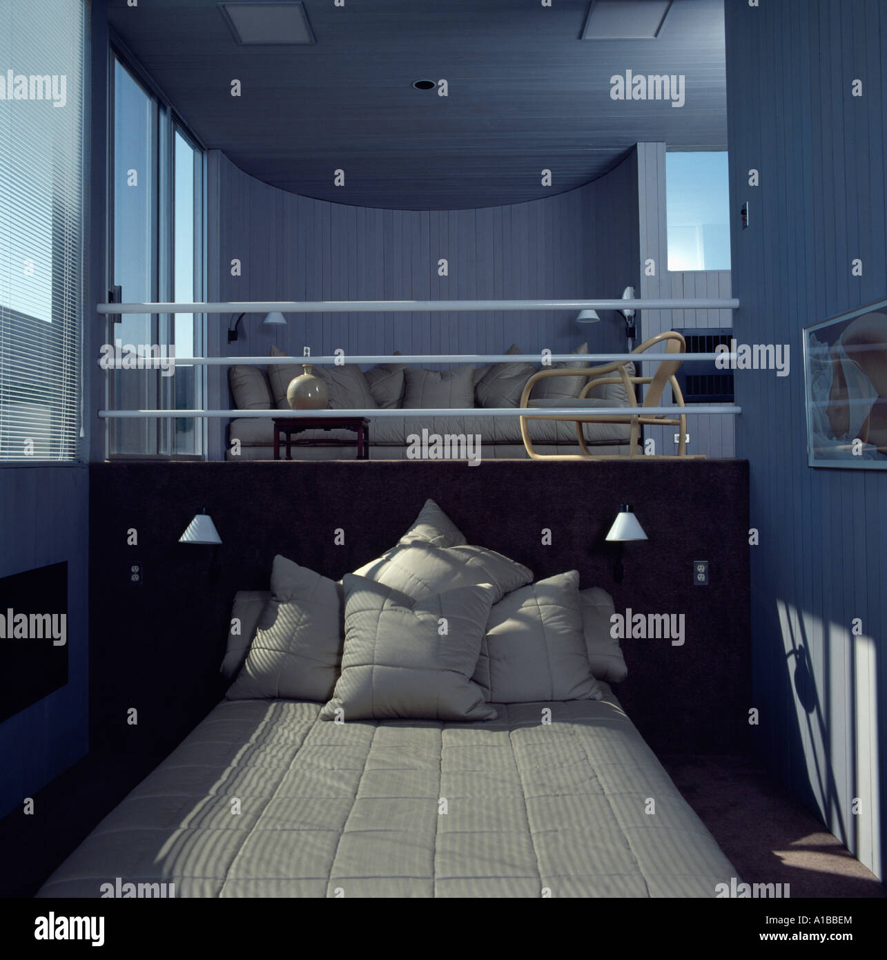 Sunken bedroom beneath livingroom mezzanine. Tailored cushions and ...