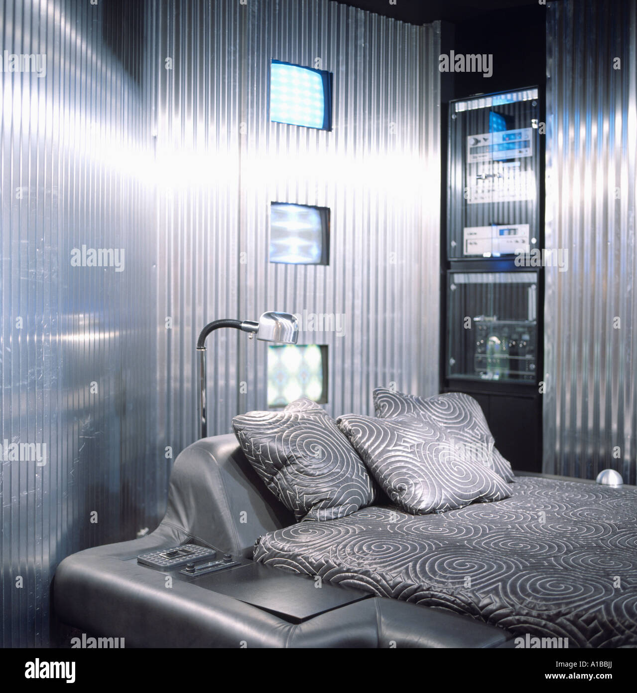 Metal walls in space-age bedroom Stock Photo - Alamy