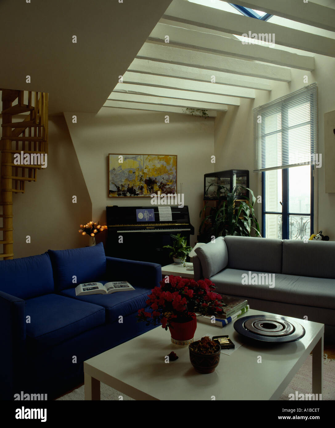 White rafter beams in livingroom with piano and grey sofas Stock Photo ...