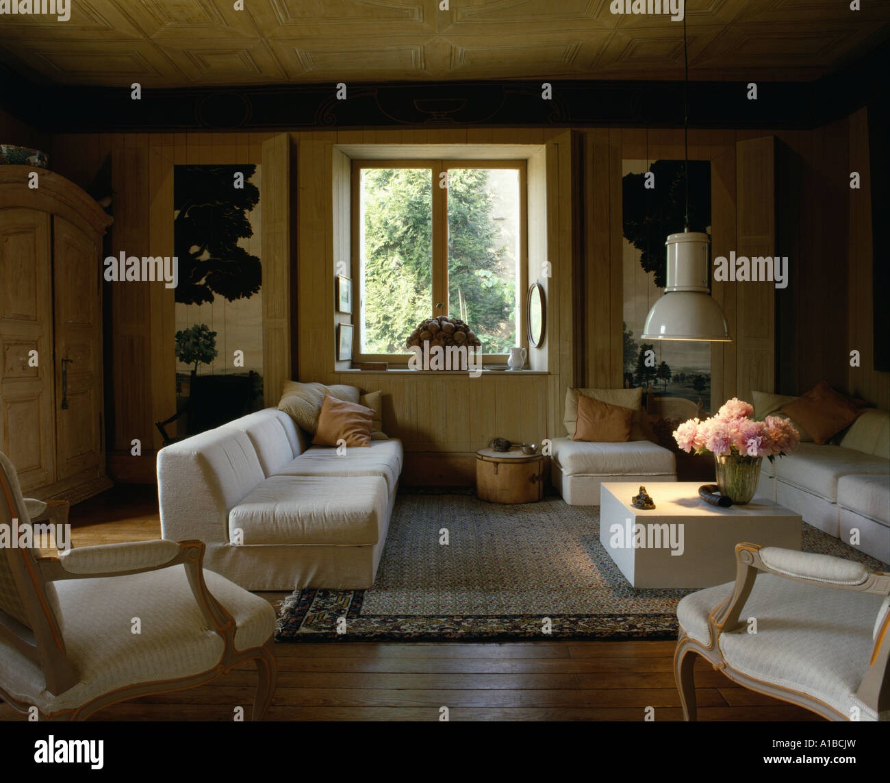 Modern white sofas either side of window Stock Photo - Alamy