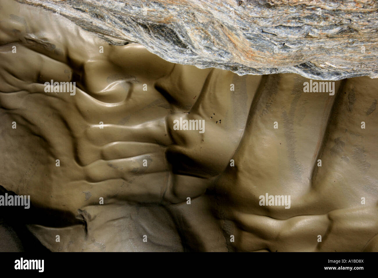 Patterns in glacial silt contrast with a granite boulder along Castner ...