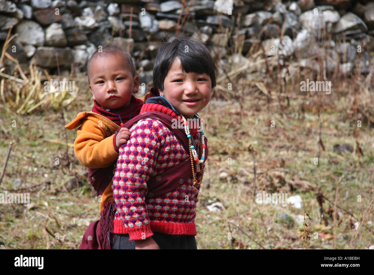 Two Bhutanese children living in a remote village high in the Himalayas ...