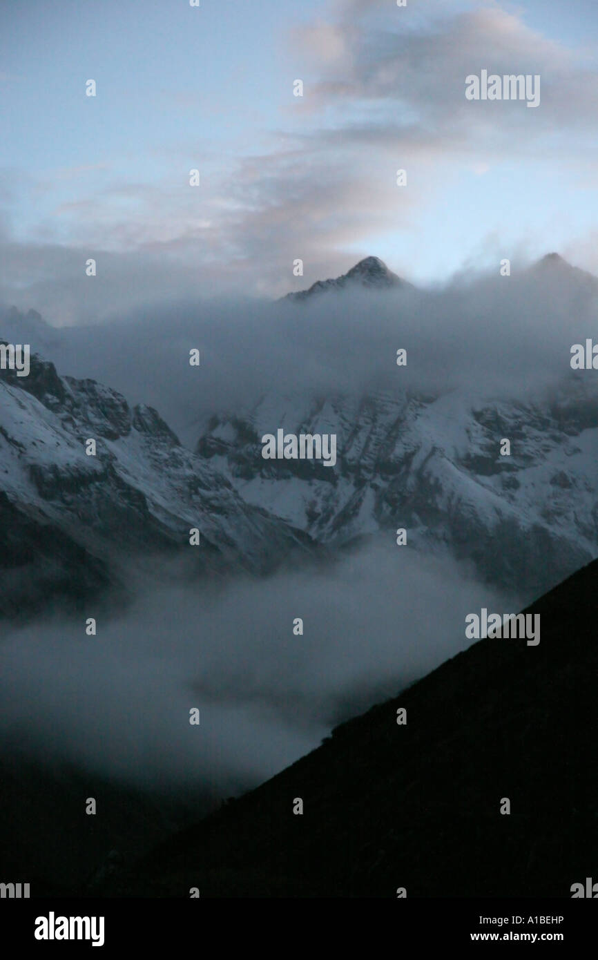 A vertical landscape of fog clearing from the Himalayas of Bhutan Stock ...