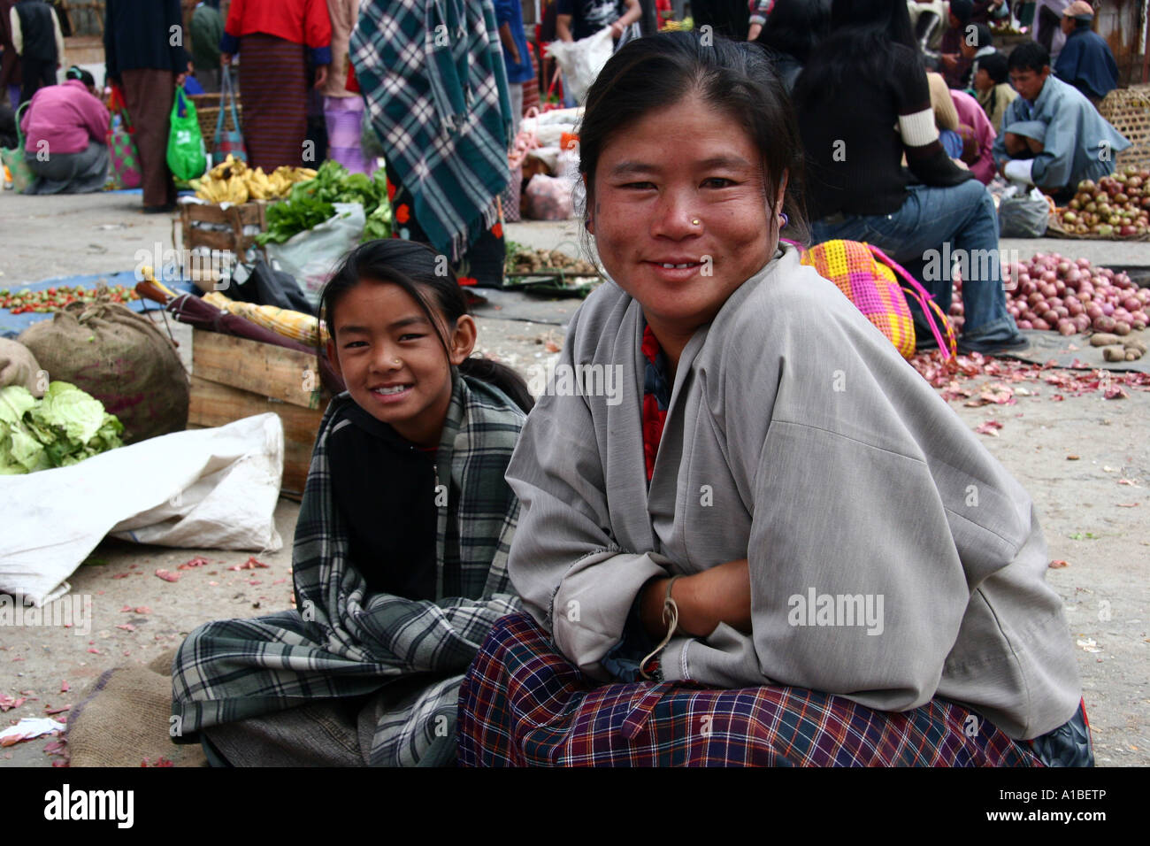 A Bhutanese woman and daughter sell vegetables at the weekly market in ...
