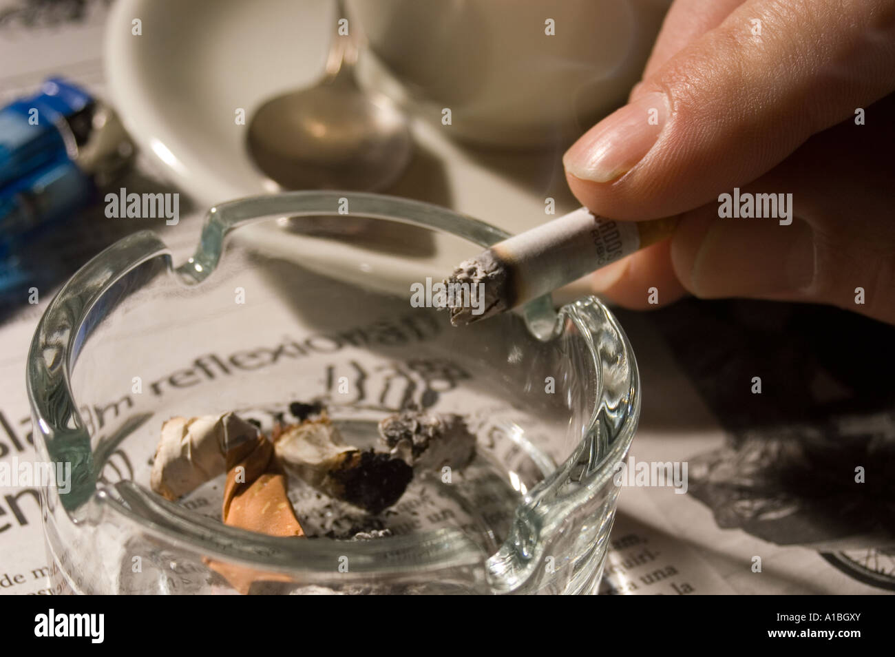 Still life about tobacco cigarette alite on an ashtray with lighter and ...