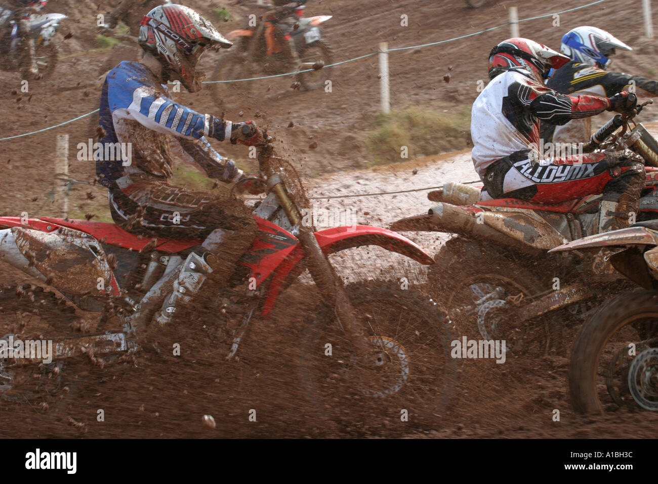 mud flying from muddy dirty wet motocross riders adult meeting ...