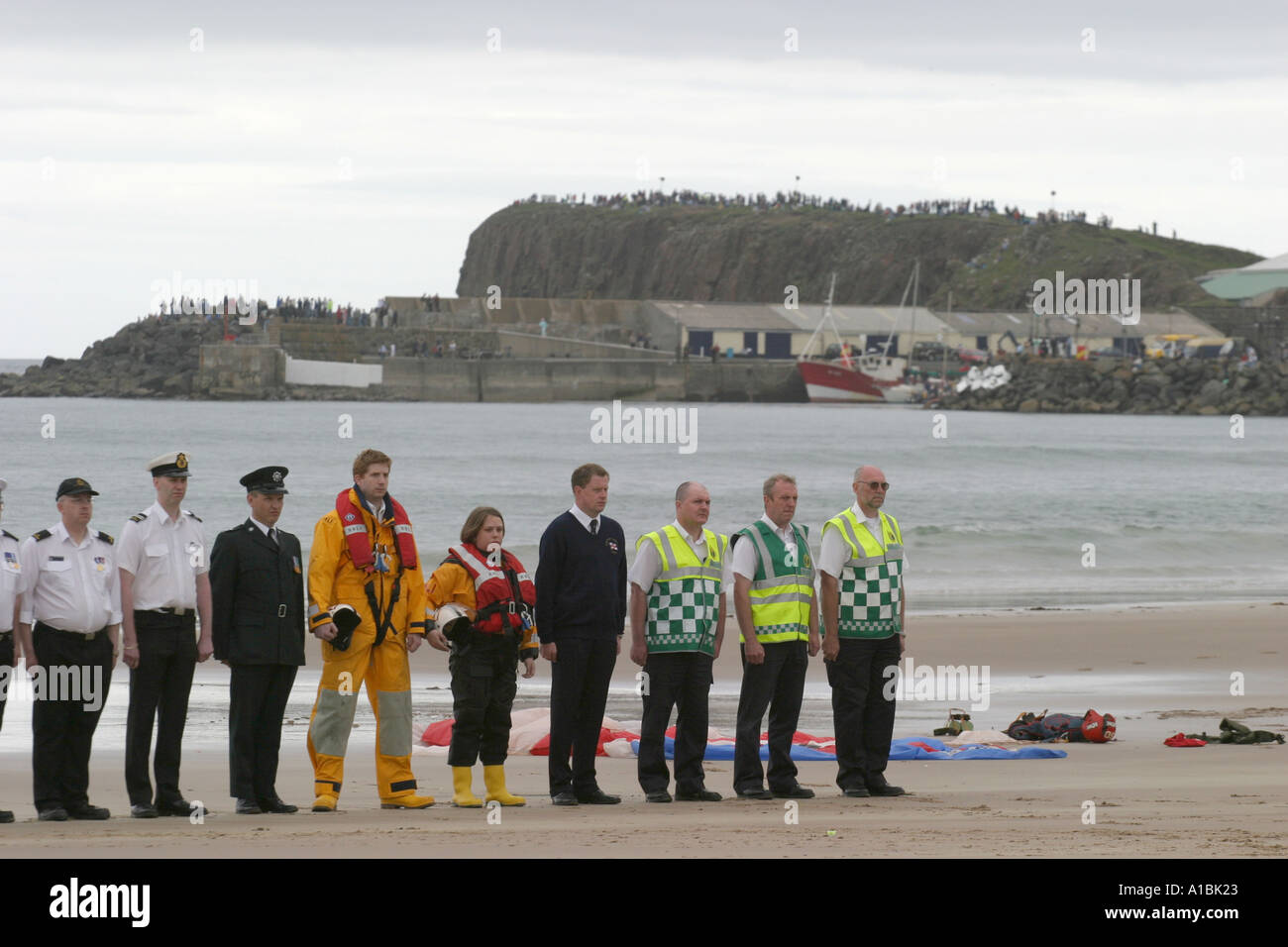 RNLI paramedics coastguard personnel with Portrush harbour behind on ...