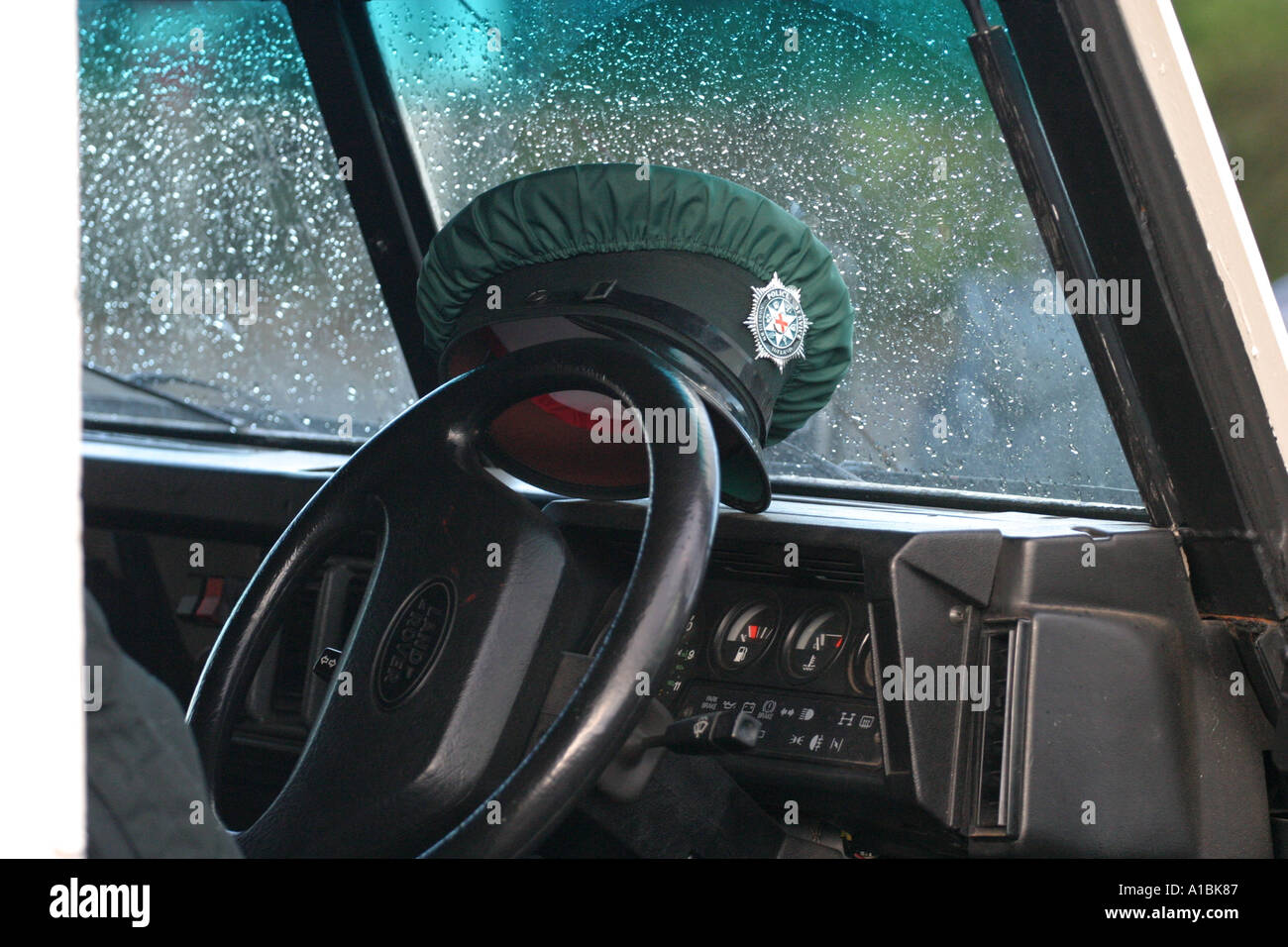 Police PSNI peaked cap with badge insignia on landrover dashboard in ...