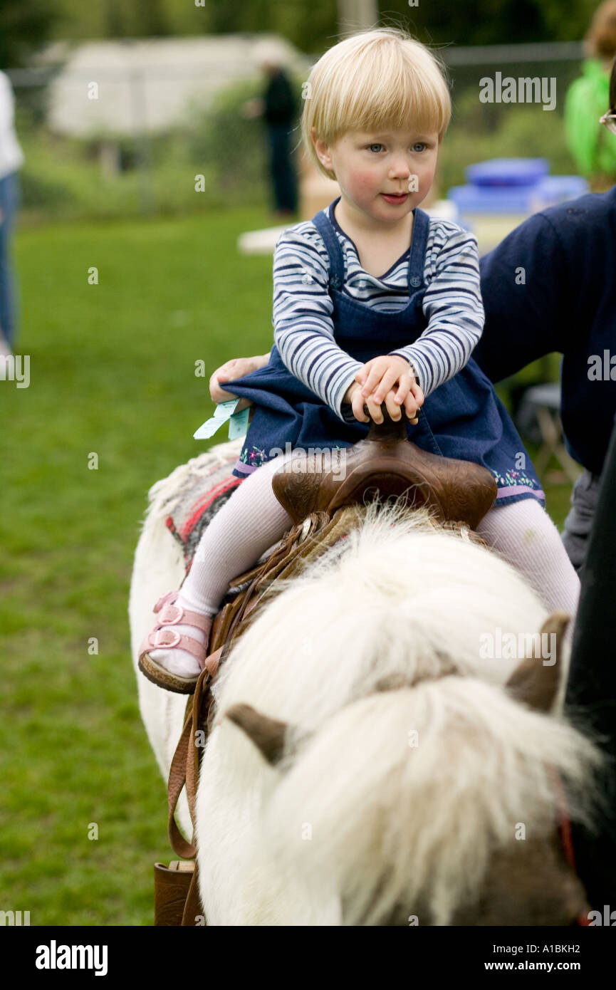 2 year old girl on pony ride Stock Photo - Alamy