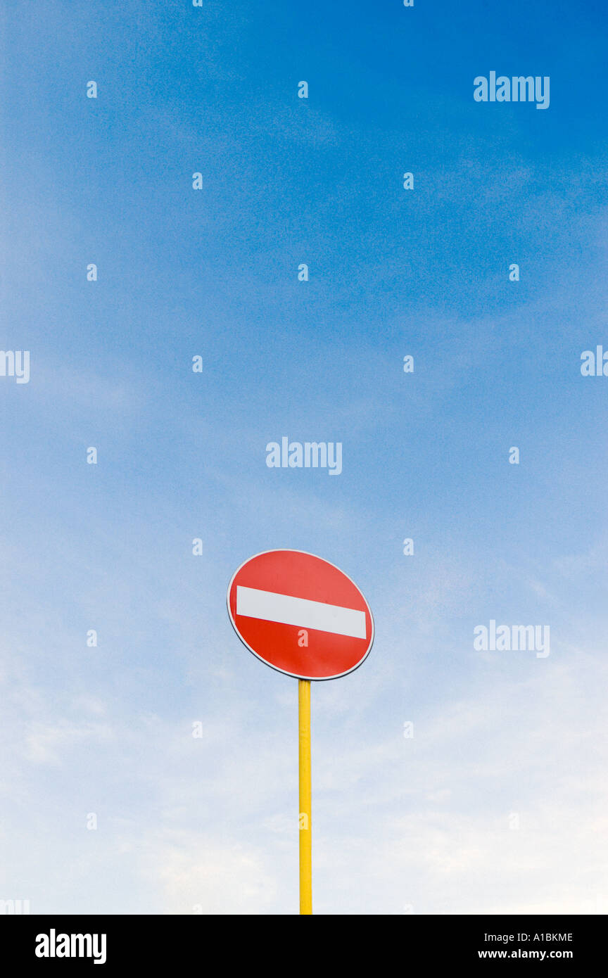 no entry road sign mounted on post and blue sky Stock Photo - Alamy
