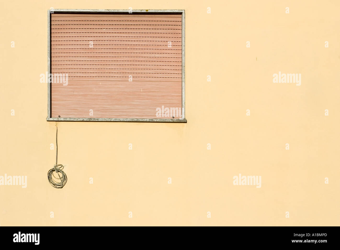 coiled electrical cable hanging from a window Stock Photo - Alamy