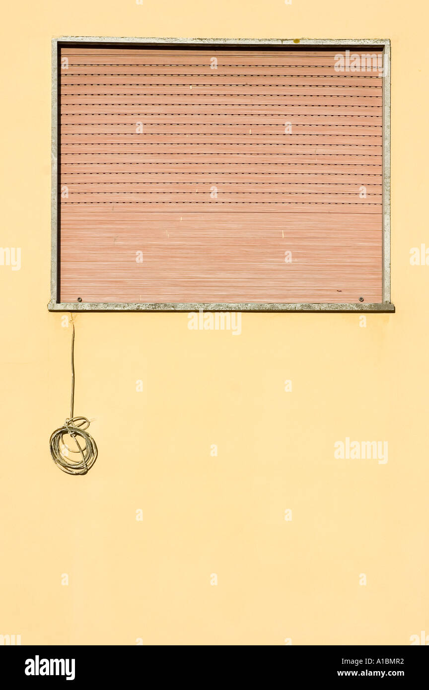 coiled electrical cable hanging from a window Stock Photo - Alamy