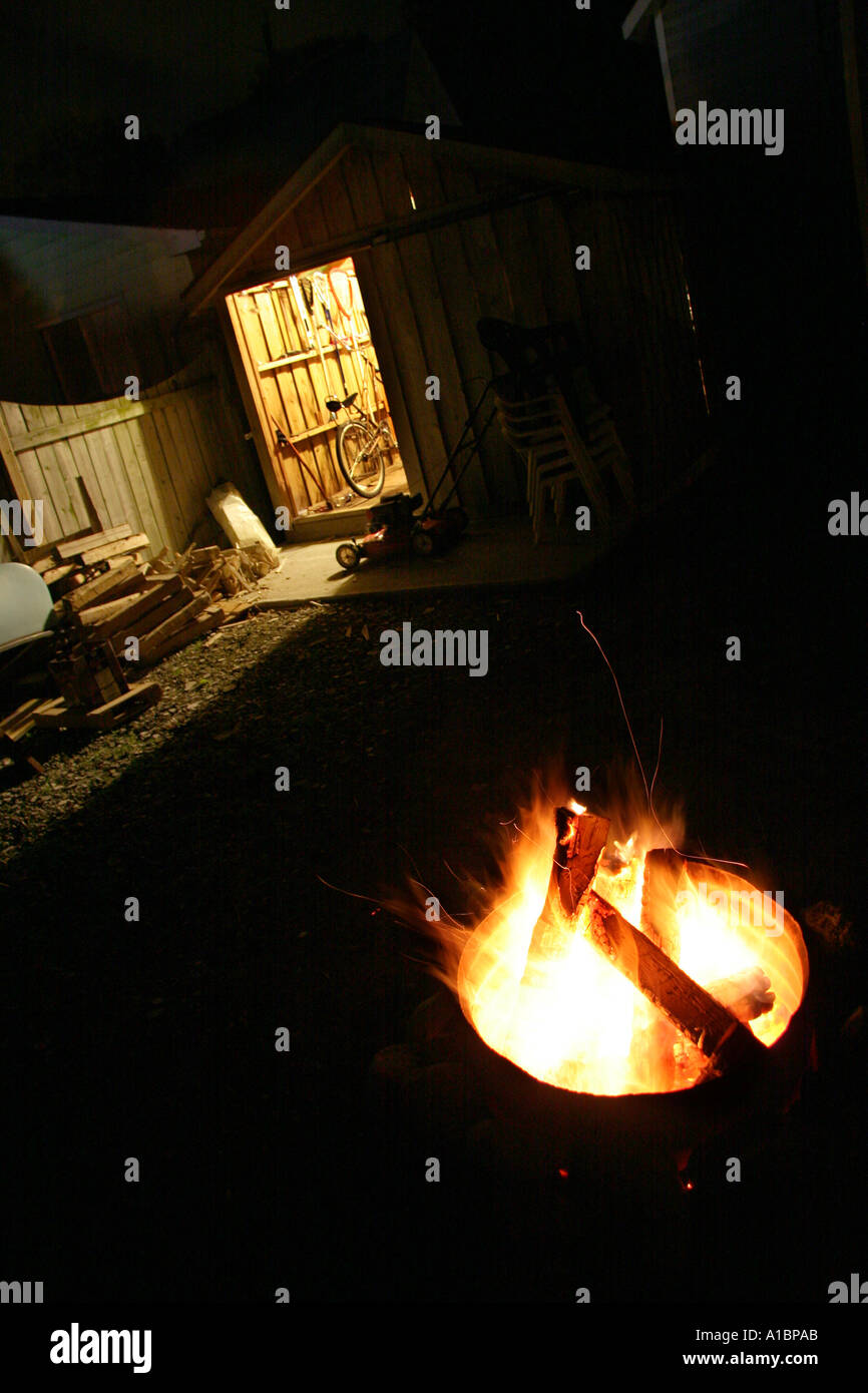 a fire burning in pit in a backyard on a nice fall night Stock Photo ...