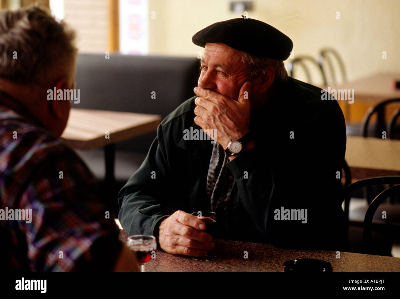 FRENCH BAR NORTHERN FRANCE MAN WEARS BERET WHILE DRINKING SMALL GLASS ...