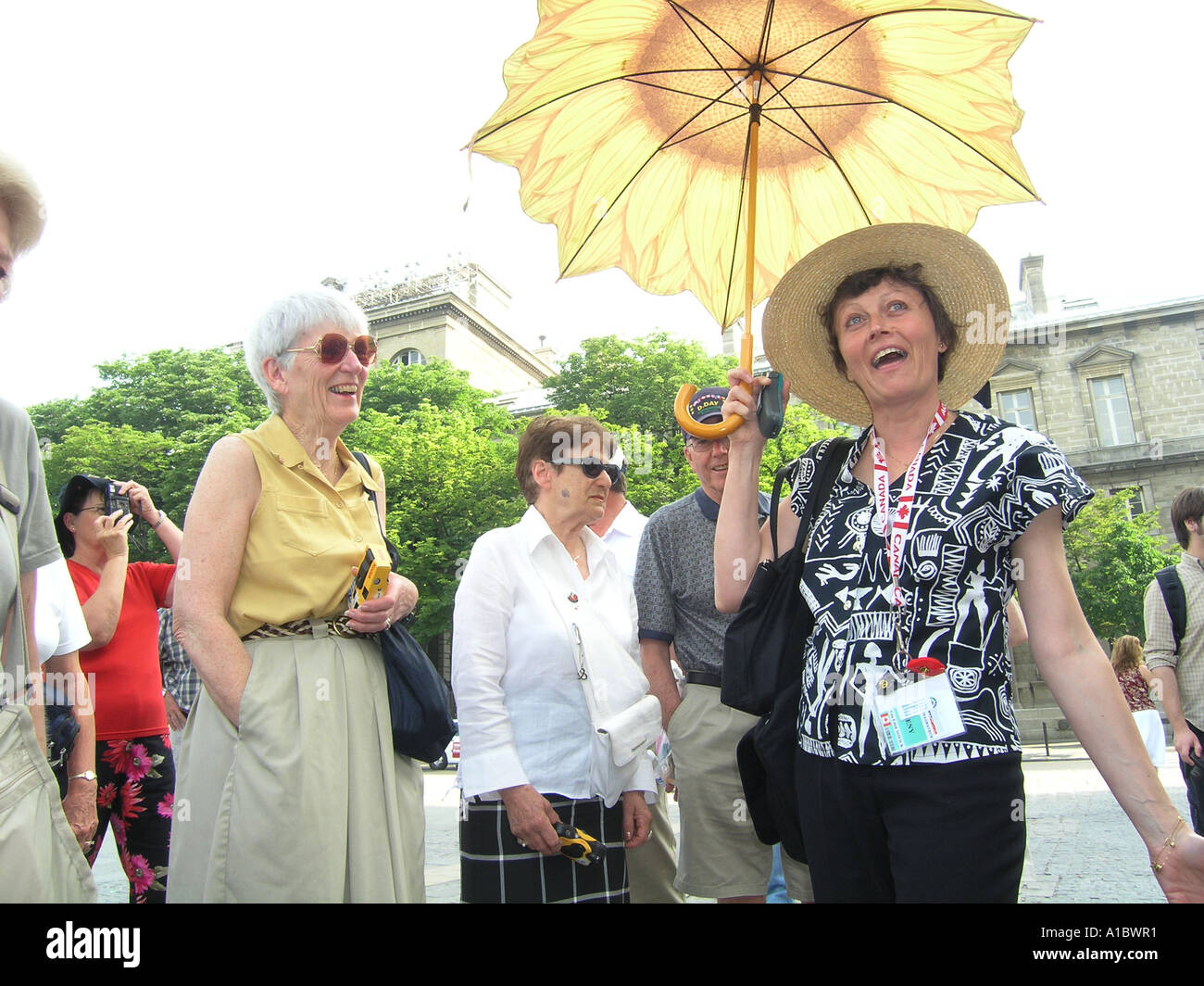 tour guide with umbrella at Notre Dame square showing tourists around ...