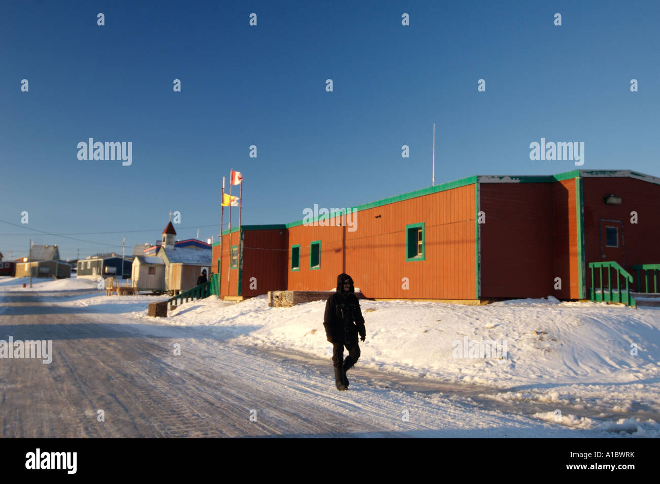 Injuit man walking past RCMP Royal Canadian Mounted Police headquarters ...