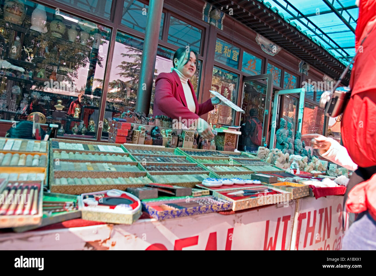 CHINA BEIJING Chinese artist carving chop for tourist customer Stock ...